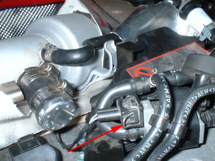 Photo: Remove the N249 connector by pushing on the metal clips, one on ...